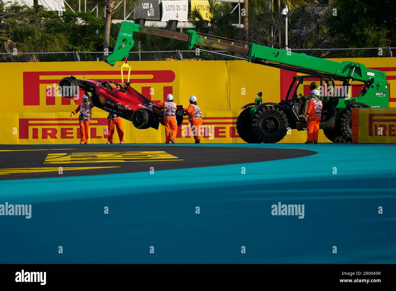 Marshalls prepare to load the damaged car of Ferrari driver Charles ...