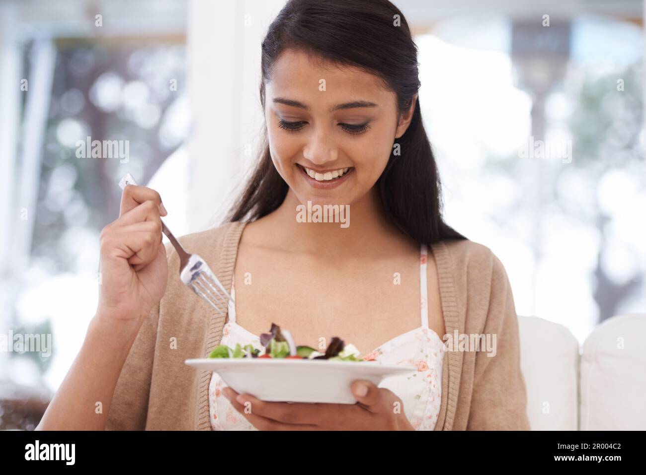Eating a balanced diet is so important. A beautiful young woman ...