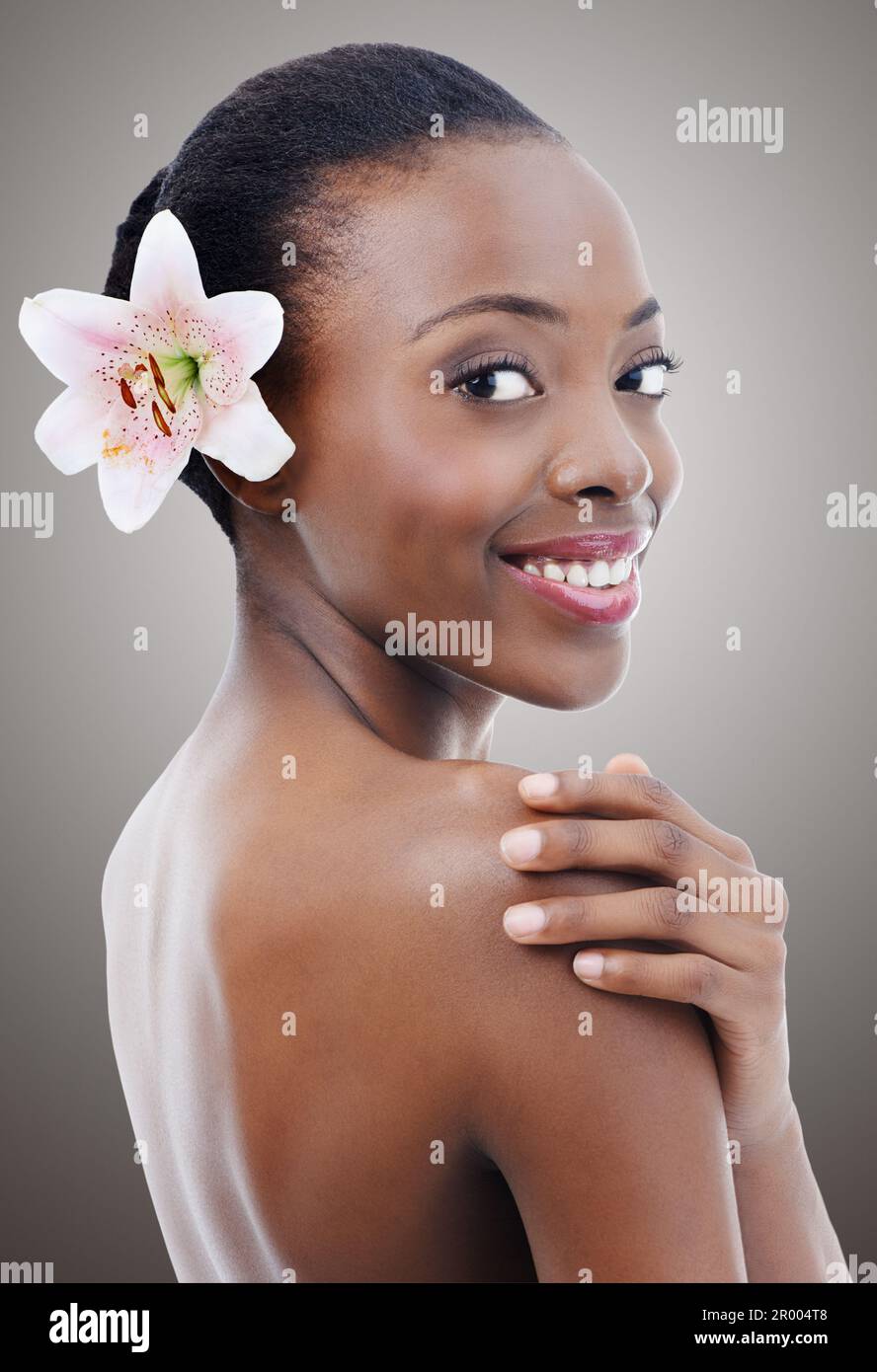 Floral touch. Portrait of a beautiful african american woman posing in ...