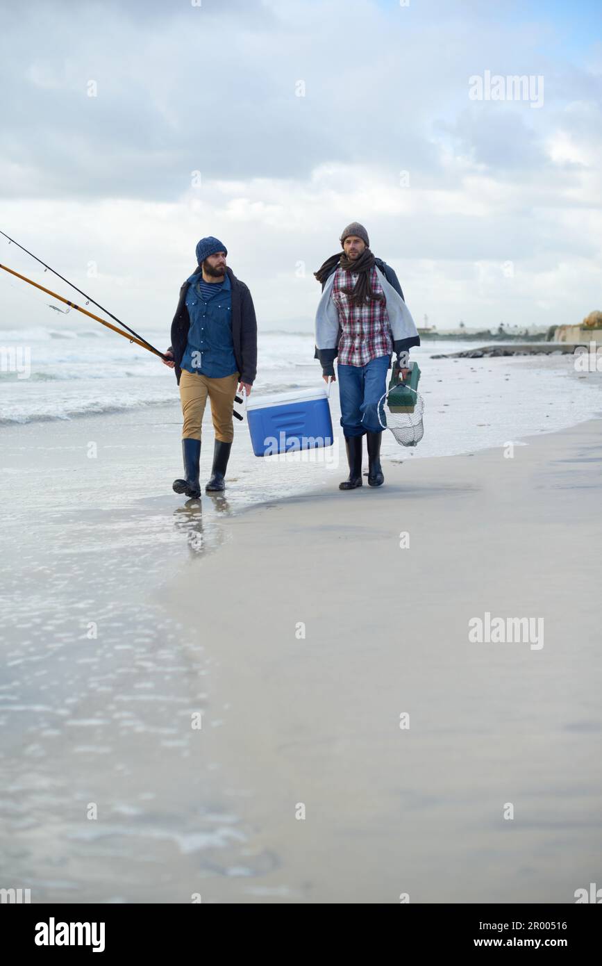 Fishing partners. a two friends going fishing on an early overcast ...