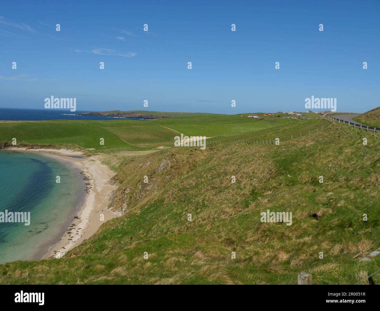A beautiful beach in the bay features stunningly turquoise waters and ...