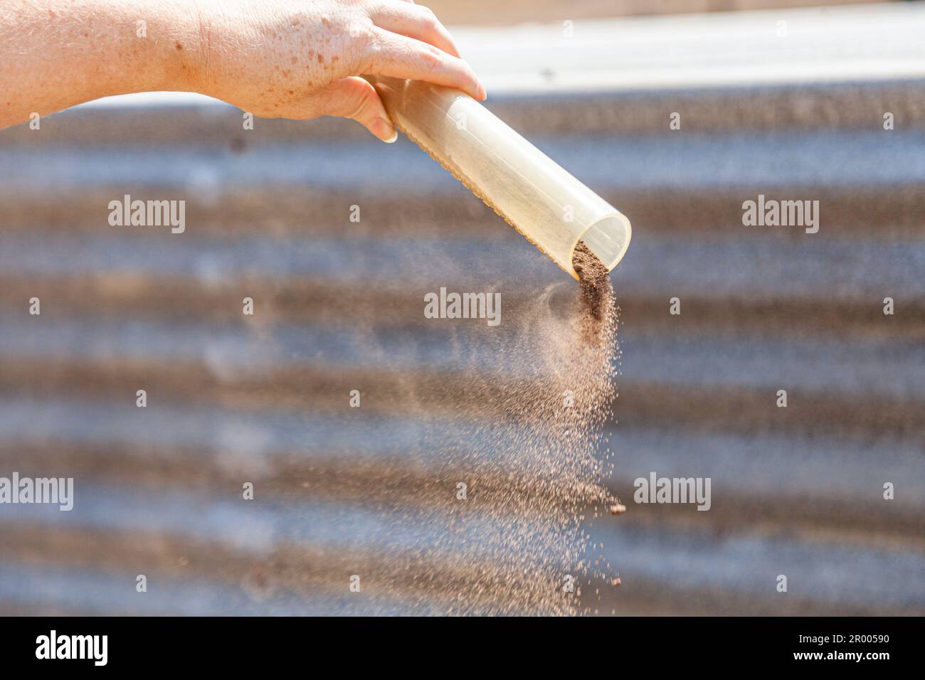 drought concept - tipping fine dusty dirt from rain gauge Stock Photo ...