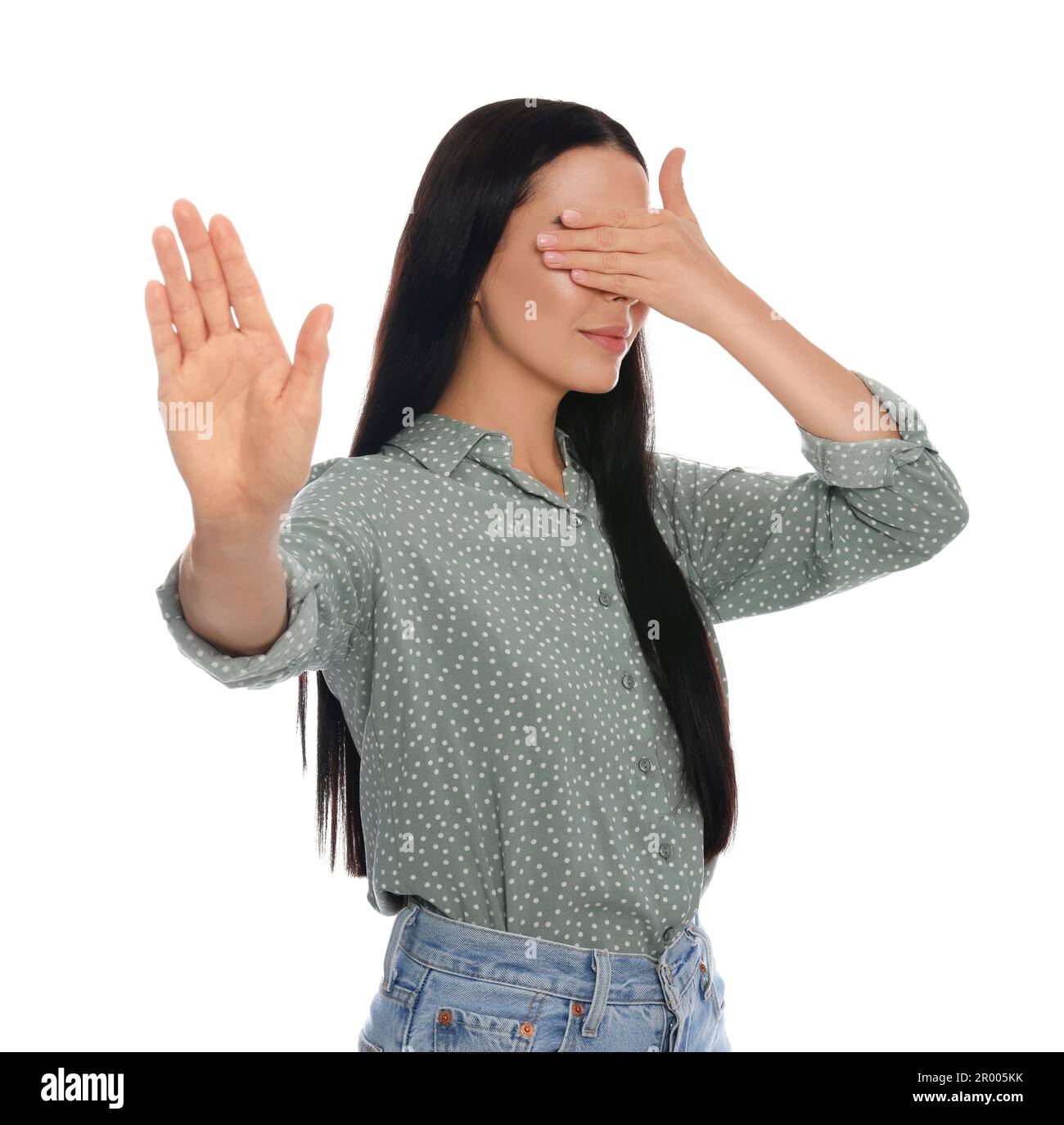 Embarrassed woman covering face with hand on white background Stock ...