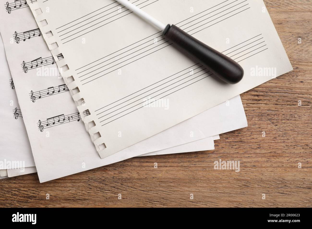 Conductor's baton and sheet music on wooden table, flat lay Stock Photo ...