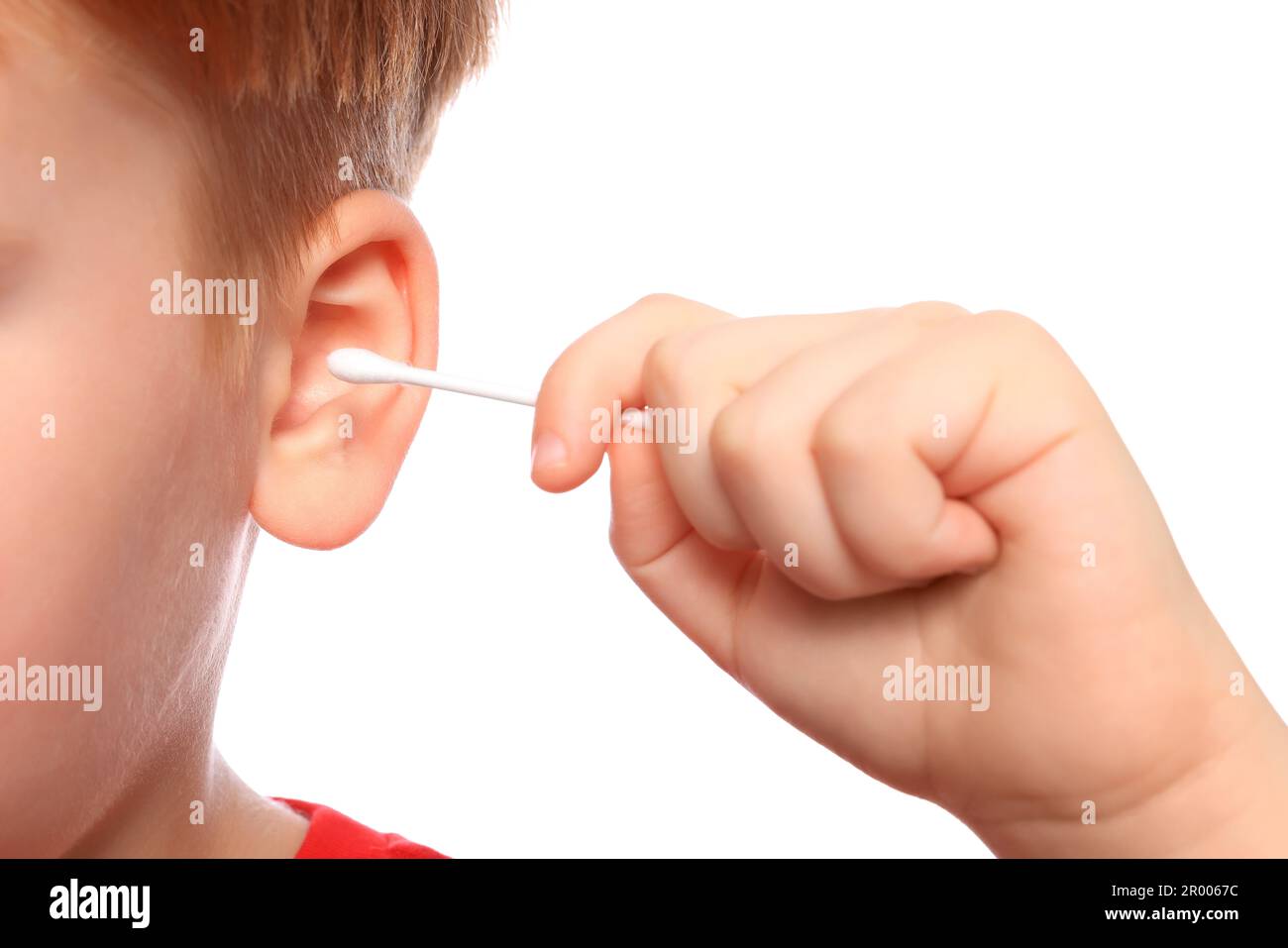Little boy cleaning ear with cotton swab on white background, closeup ...