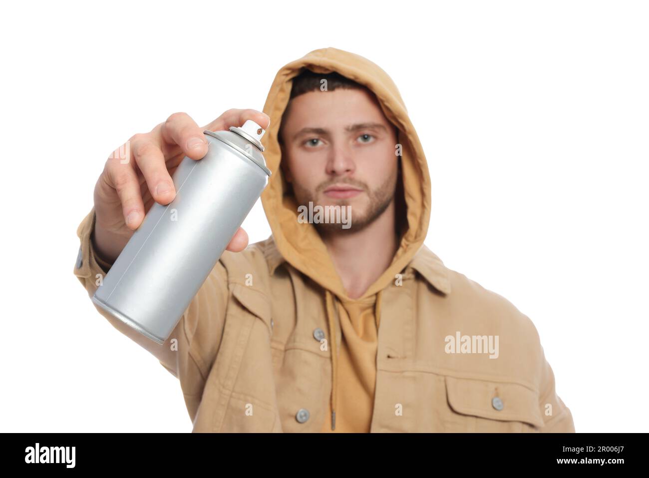 Handsome man holding can of spray paint on white background Stock Photo ...