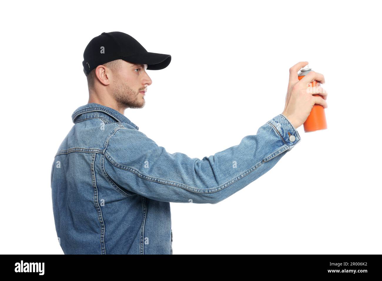 Handsome man holding spray paint against white background Stock Photo ...