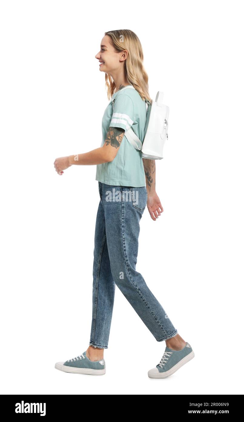 Beautiful young with backpack woman walking on white background Stock ...