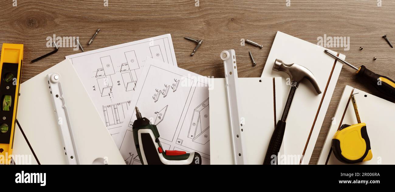 Flat lay composition with furniture assembly parts and tools on wooden ...