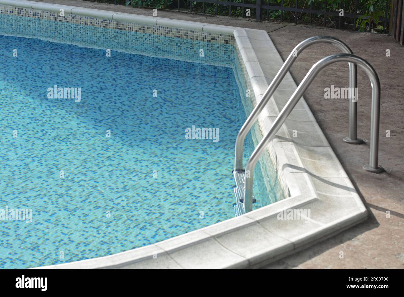 Ladder with grab bars in outdoor swimming pool Stock Photo - Alamy