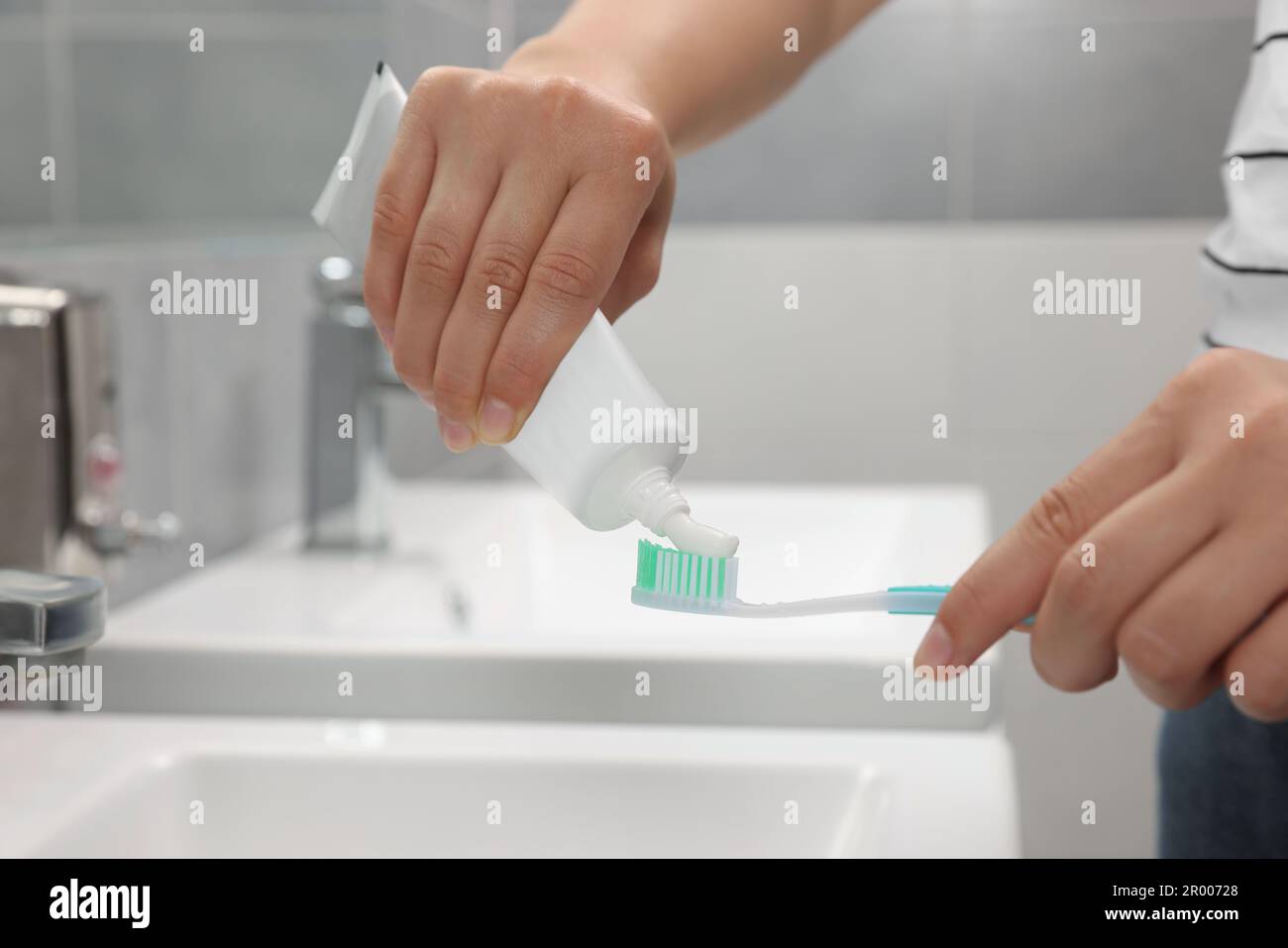 Woman applying toothpaste on brush in bathroom, closeup Stock Photo - Alamy