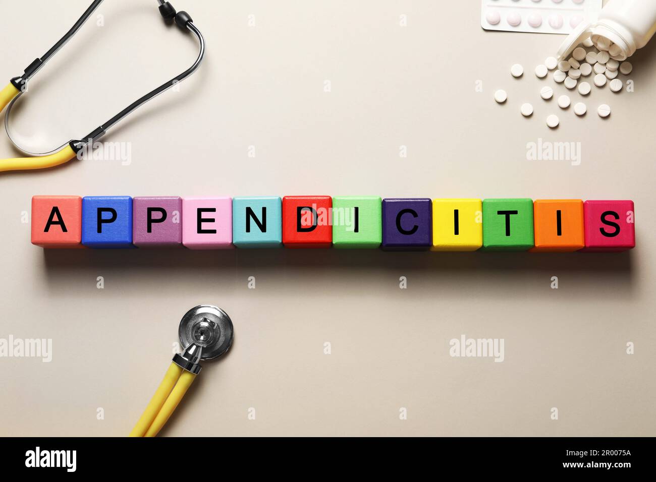 Word Appendicitis made of color cubes, pills and stethoscope on light ...