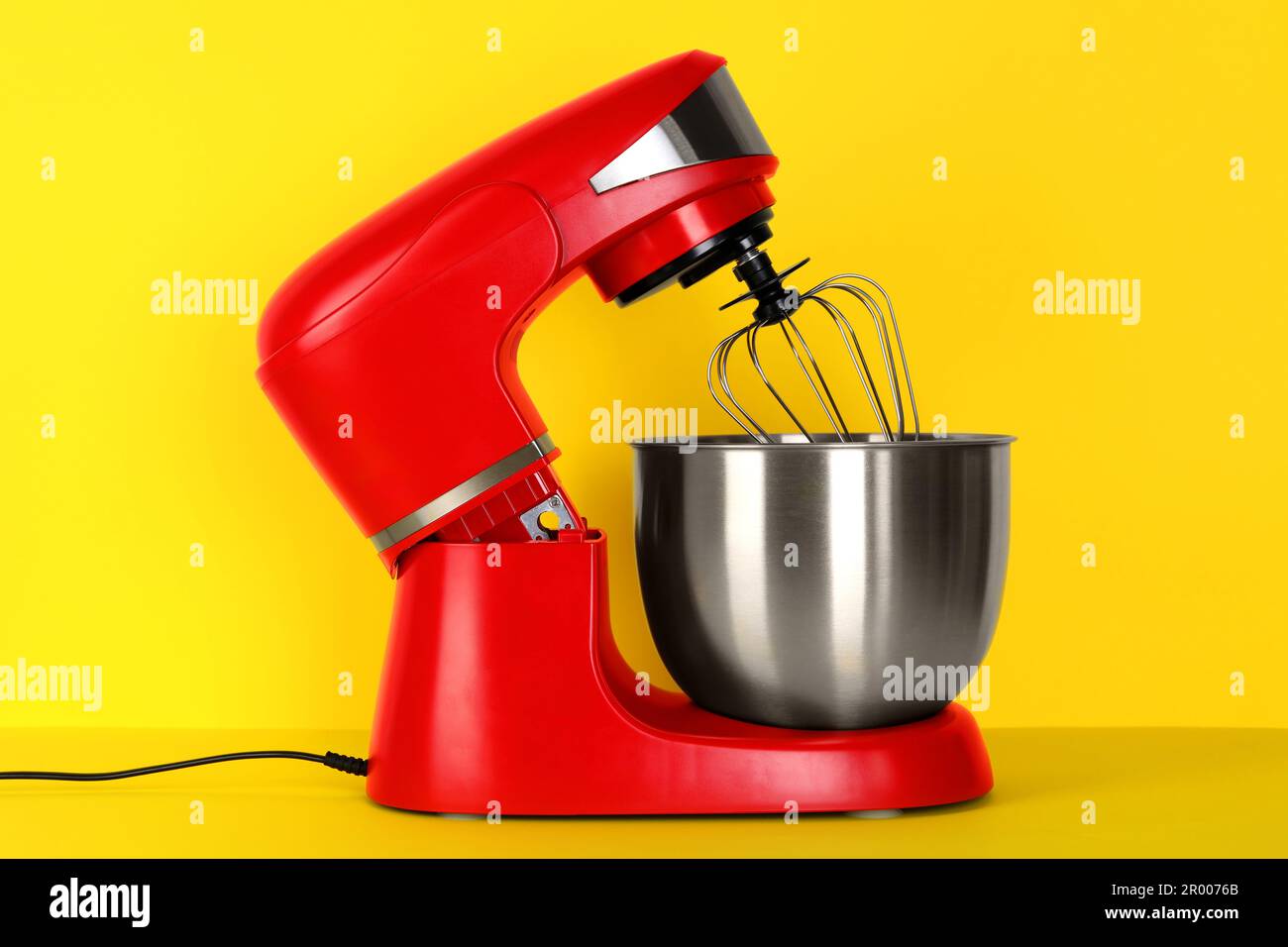Modern red stand mixer on yellow background Stock Photo - Alamy