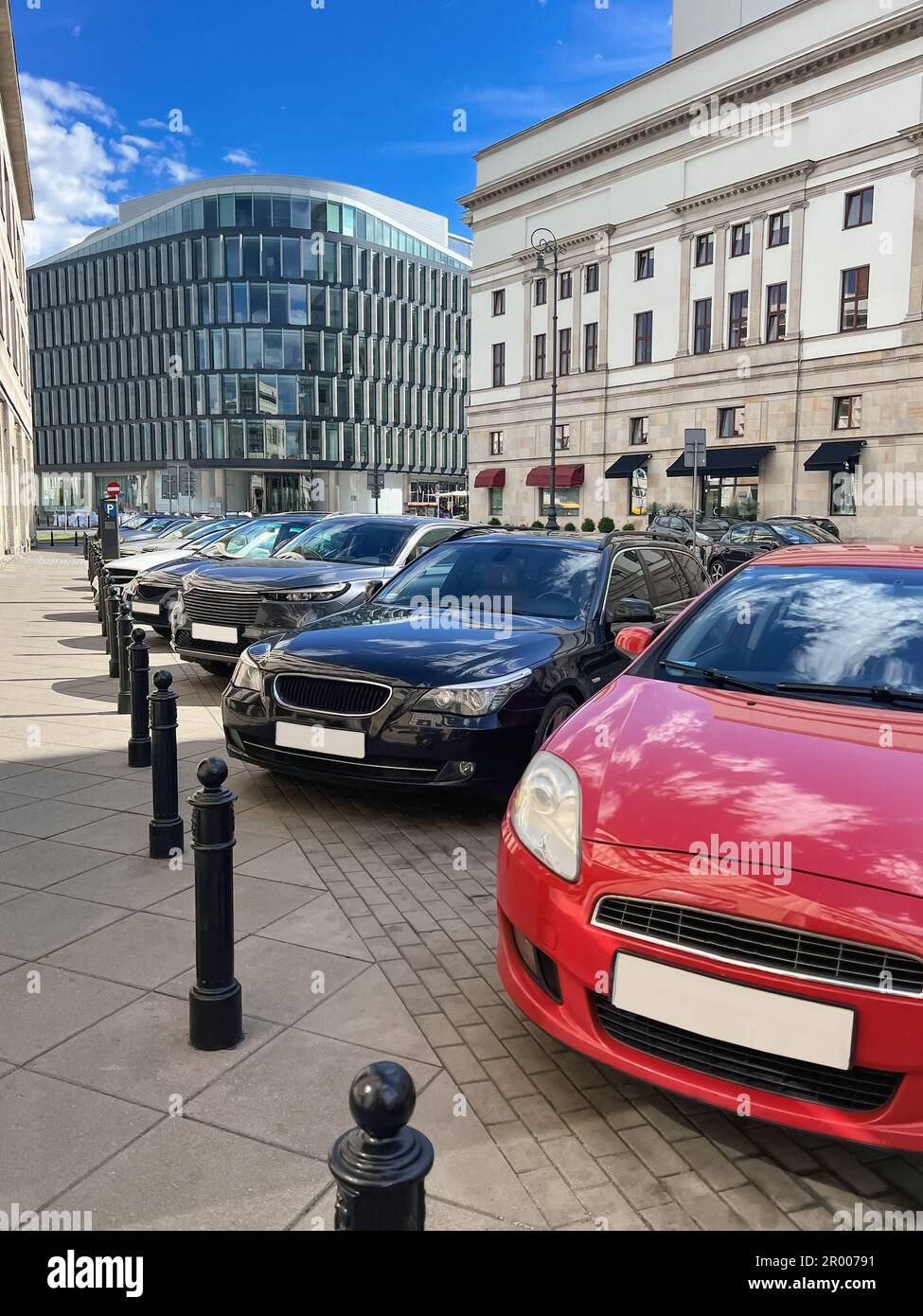 Different modern cars parked on city street Stock Photo - Alamy