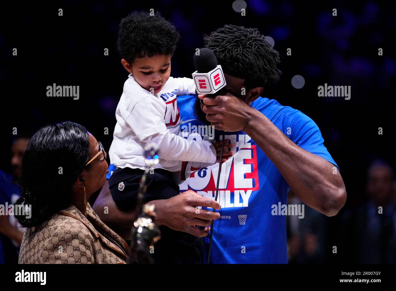 Philadelphia 76ers' Joel Embiid, right, accompanied by his son Arthur ...