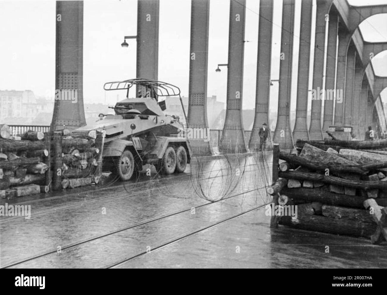 The leader of a German Reconnaissance party posts two armored cars on ...