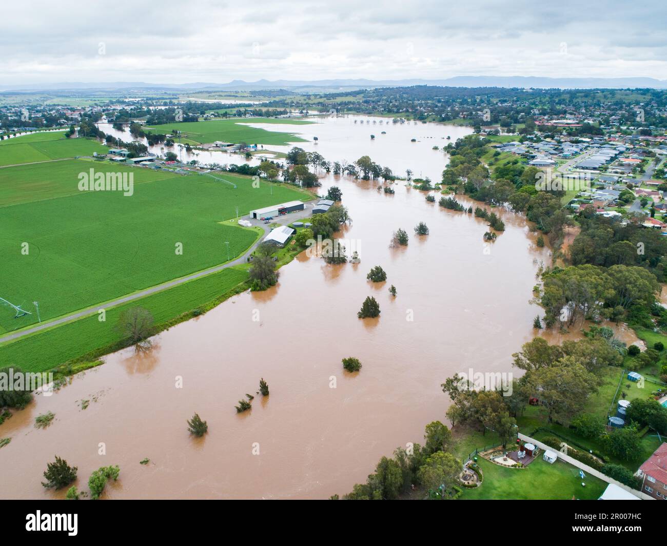Floodwaters overflowing banks of Hunter River in Singleton seen from aerial view over wet ...