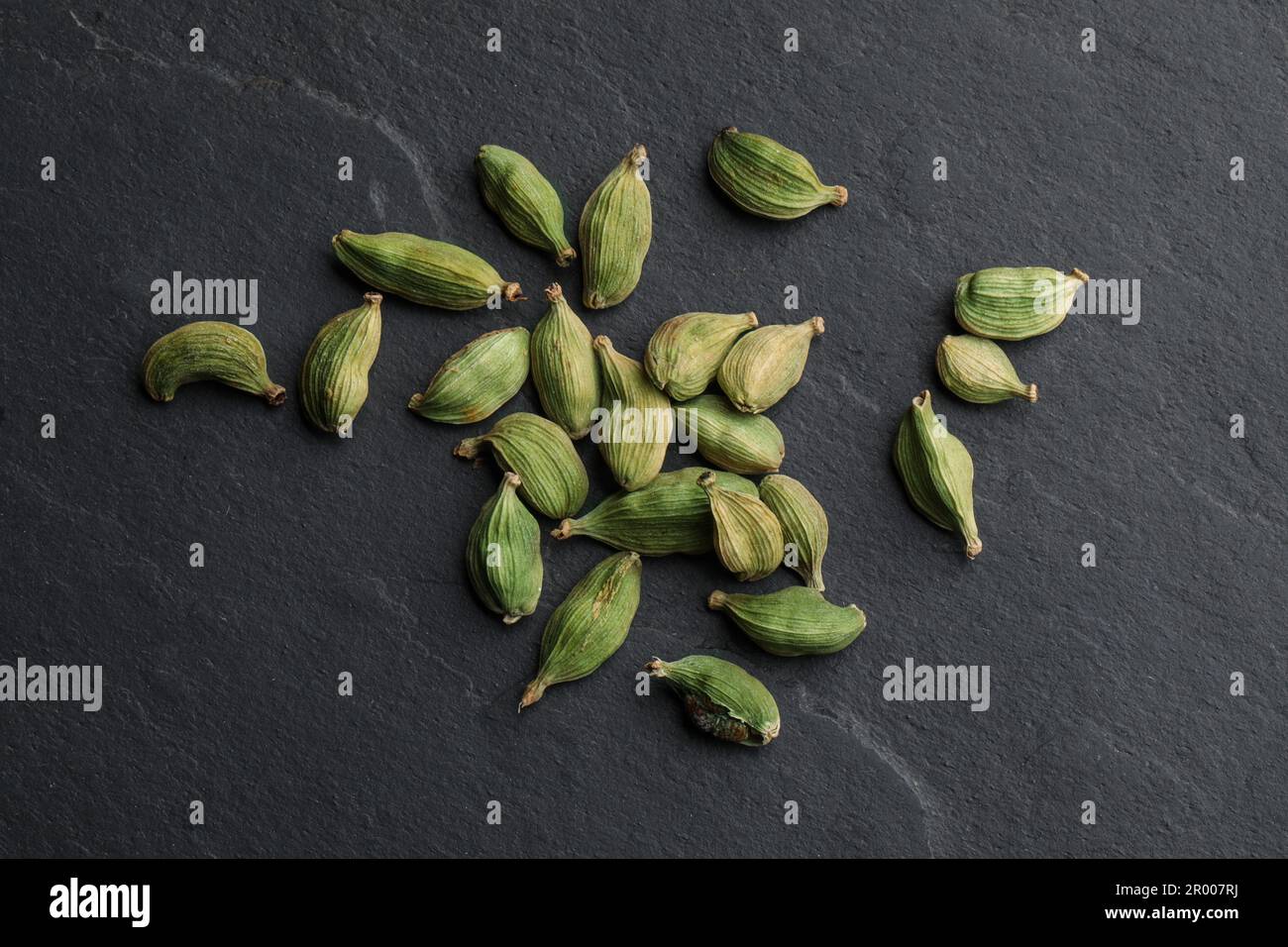 Dry cardamom pods on black table, top view Stock Photo - Alamy
