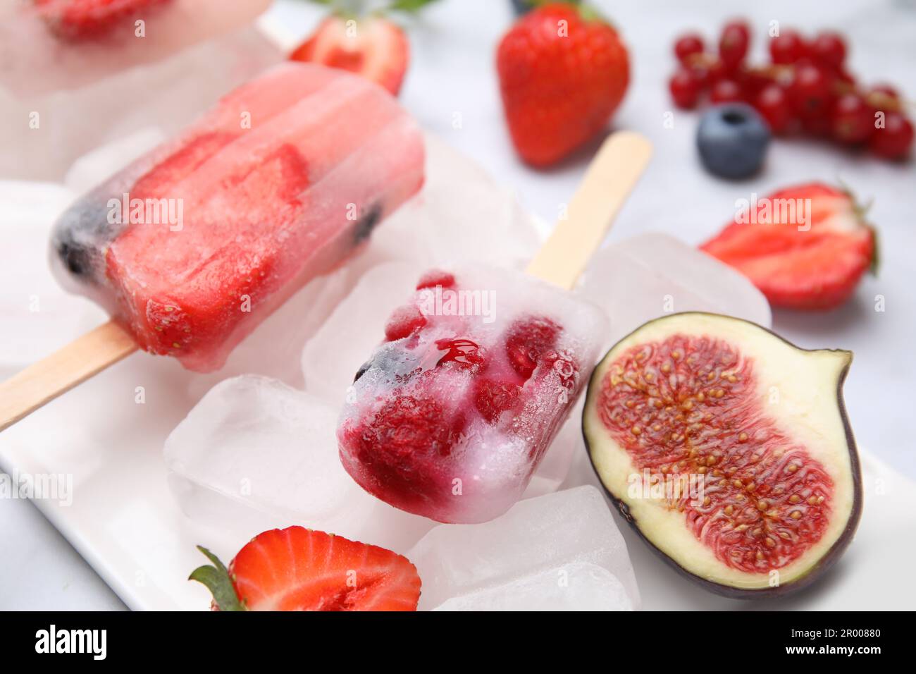 Tasty refreshing fruit and berry ice pops on light table, closeup Stock ...