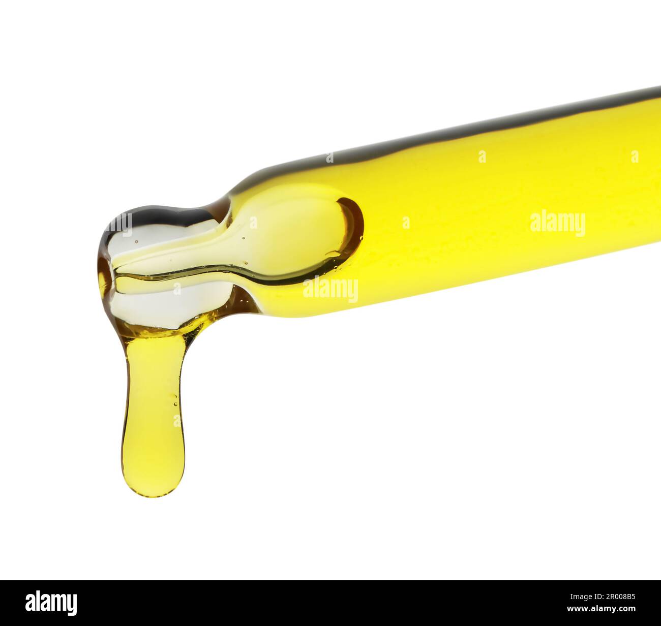 Dripping yellow facial serum from pipette on white background, closeup ...