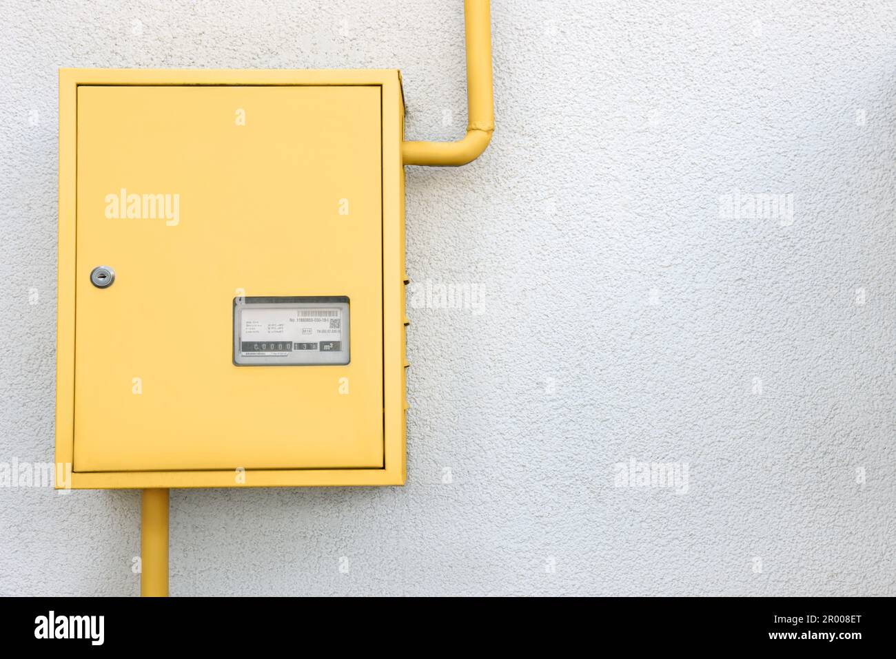 Gas meter box and pipes near grey wall outdoors. Space for text Stock ...