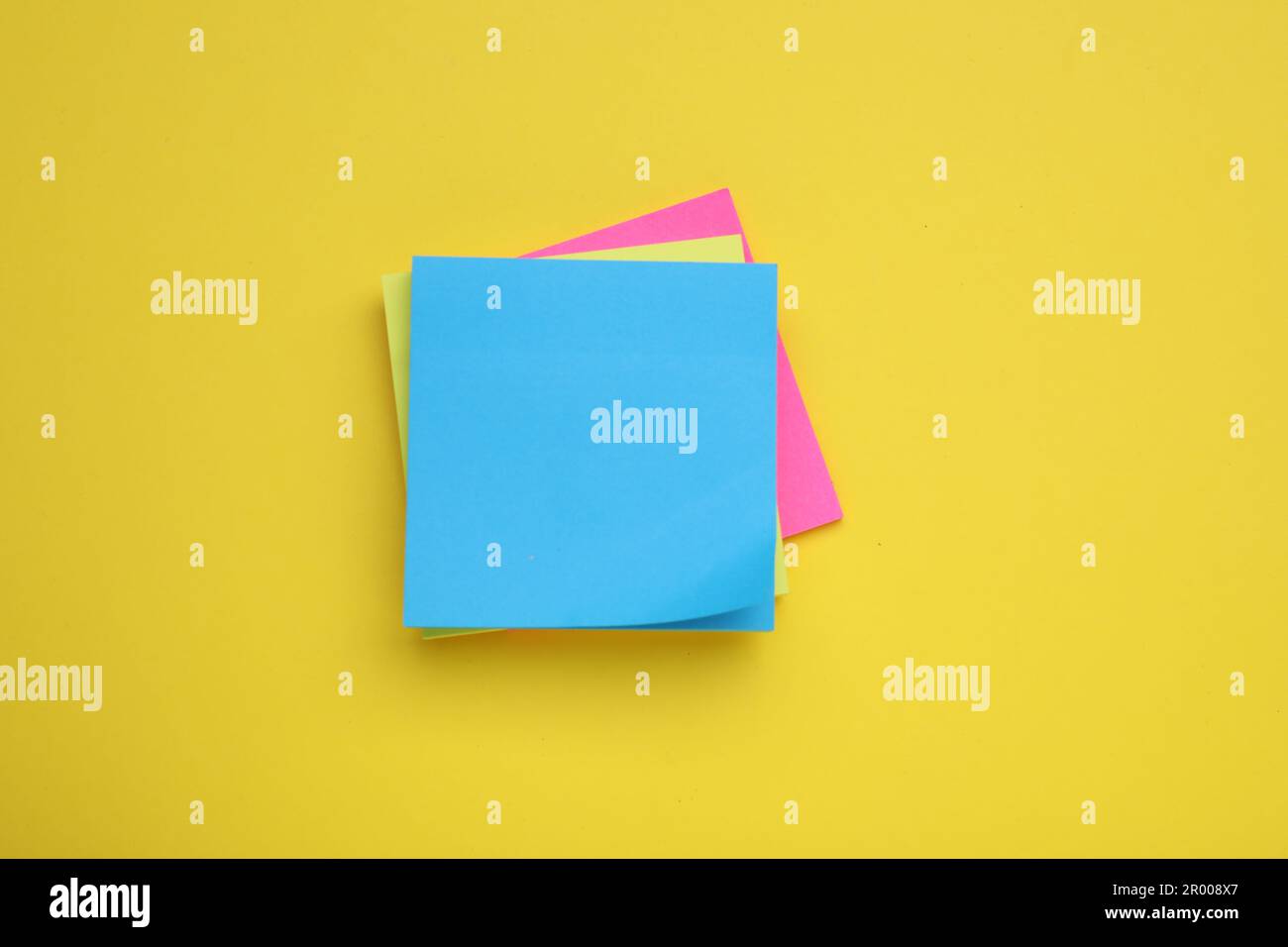 Paper notes on yellow background, top view Stock Photo - Alamy