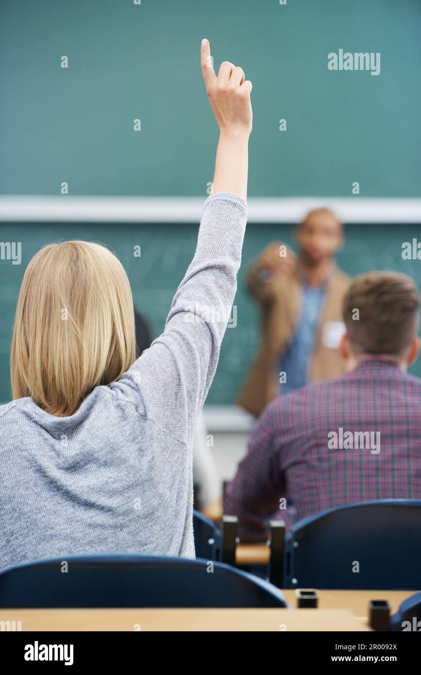 Working her way to a distinction. Rearview shot of a young woman ...