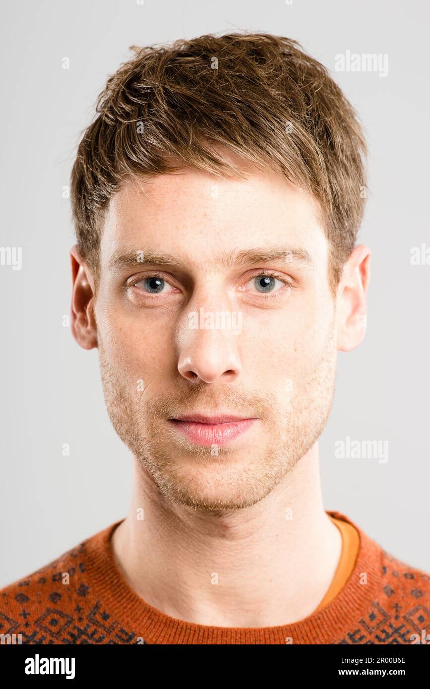 Youll get no smile out of me. a handsome young man standing alone in ...