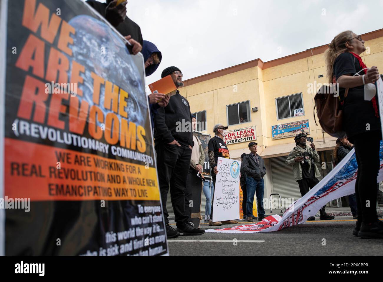 Protesters hold placards, during the demonstration. The Revcoms of Los ...