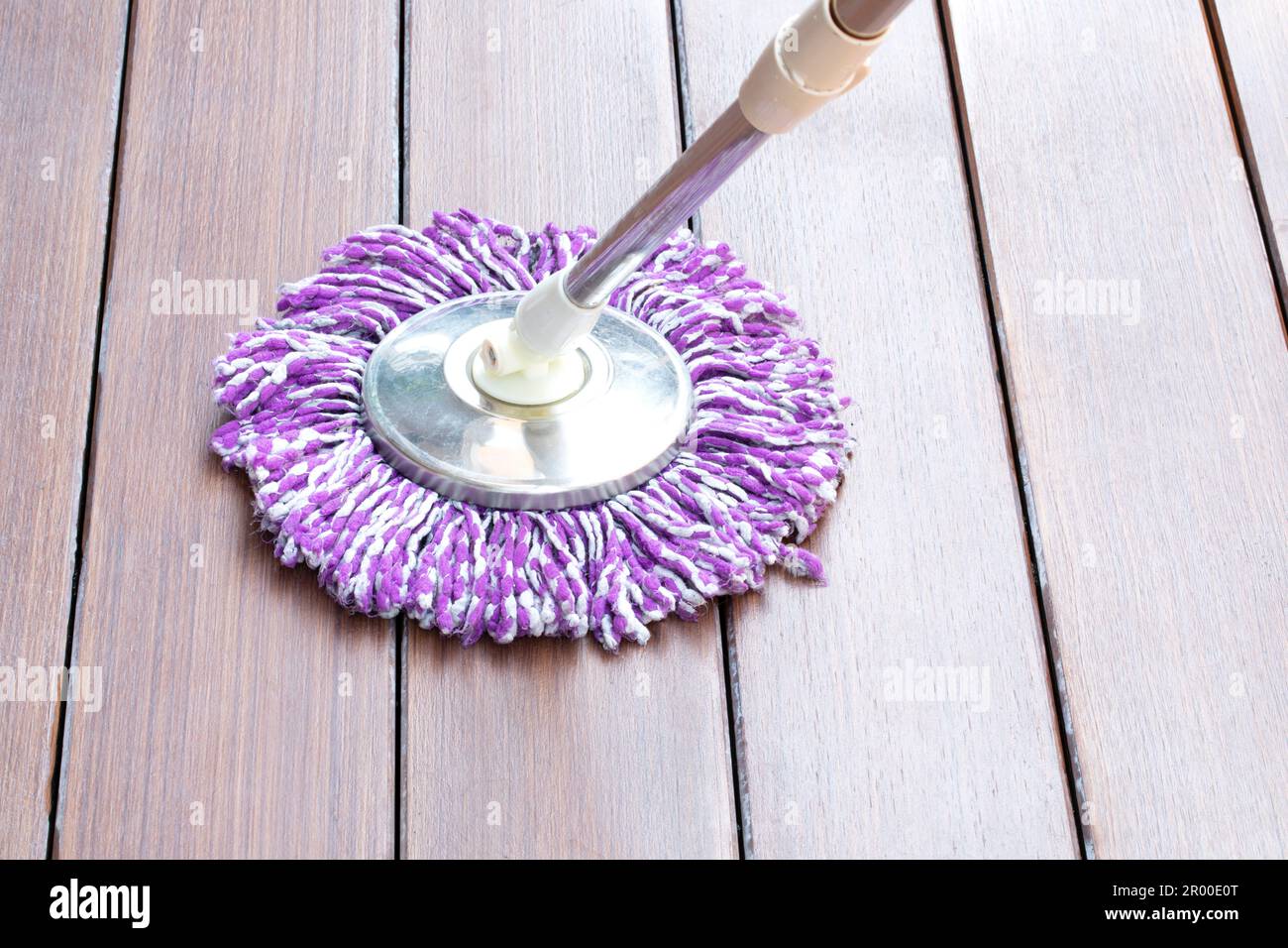 Cleaning wooden floor with purple mop top view Stock Photo - Alamy