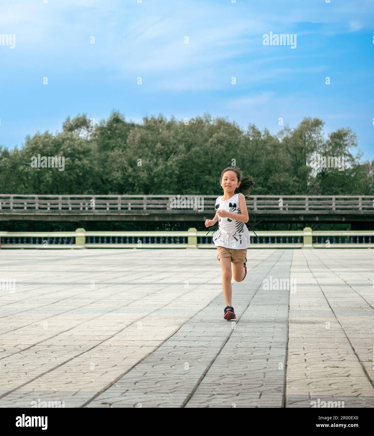 Asian child girl running out door with smile Stock Photo - Alamy