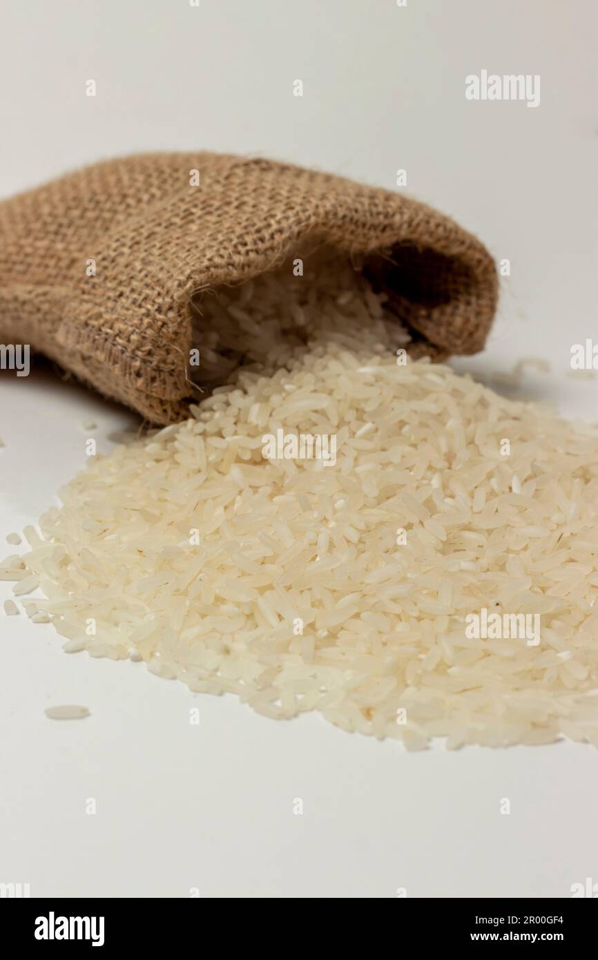 spilled rice grains - white background Stock Photo - Alamy