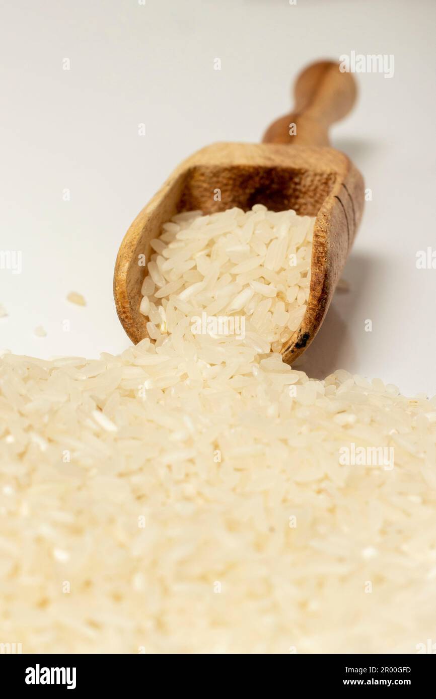 spilled rice grains - white background Stock Photo - Alamy