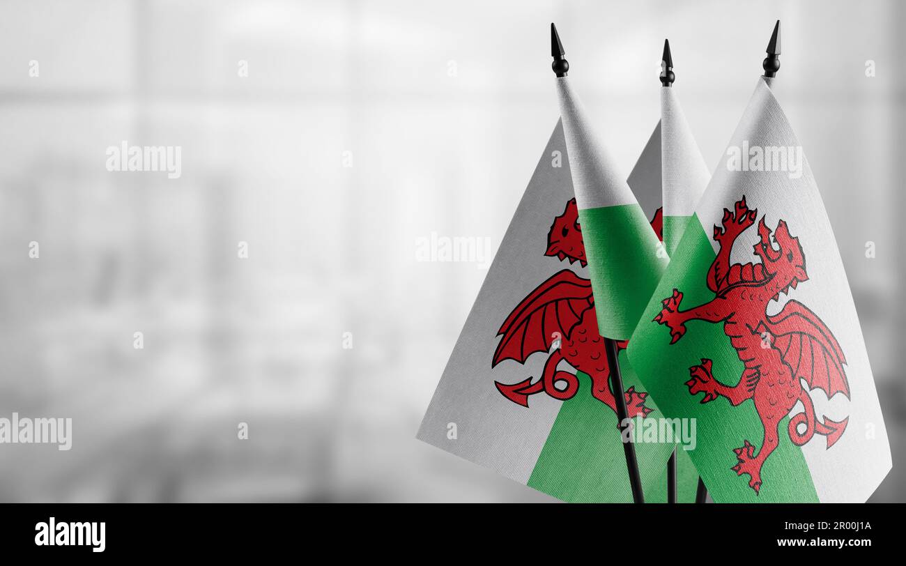 Small flags of the Wales on an abstract blurry background Stock Photo ...