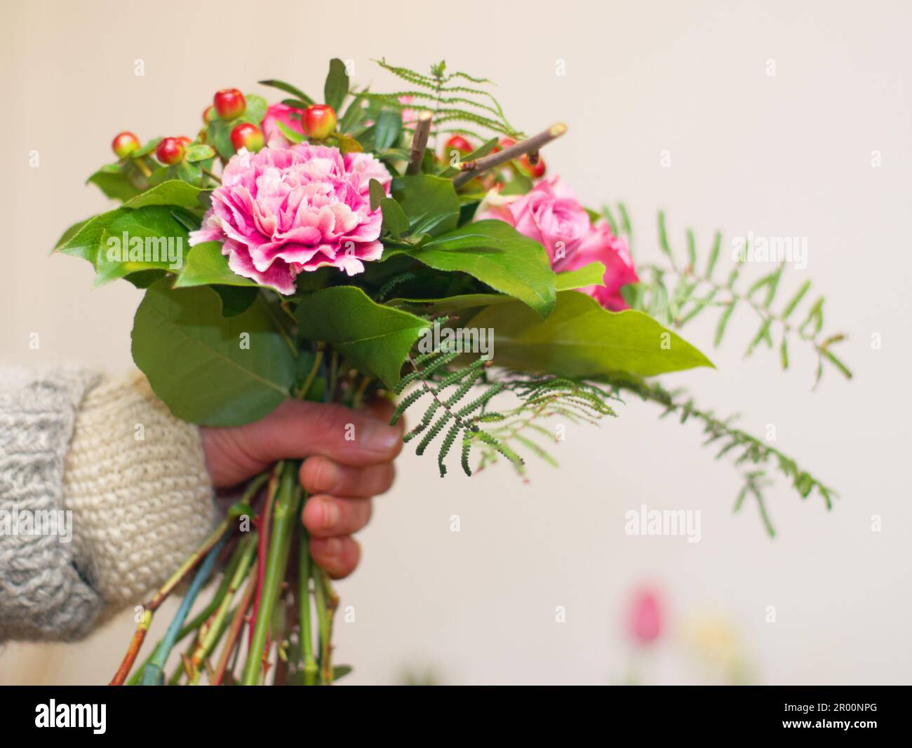Closeup, hand and woman with a bouquet, gift and care with beauty ...