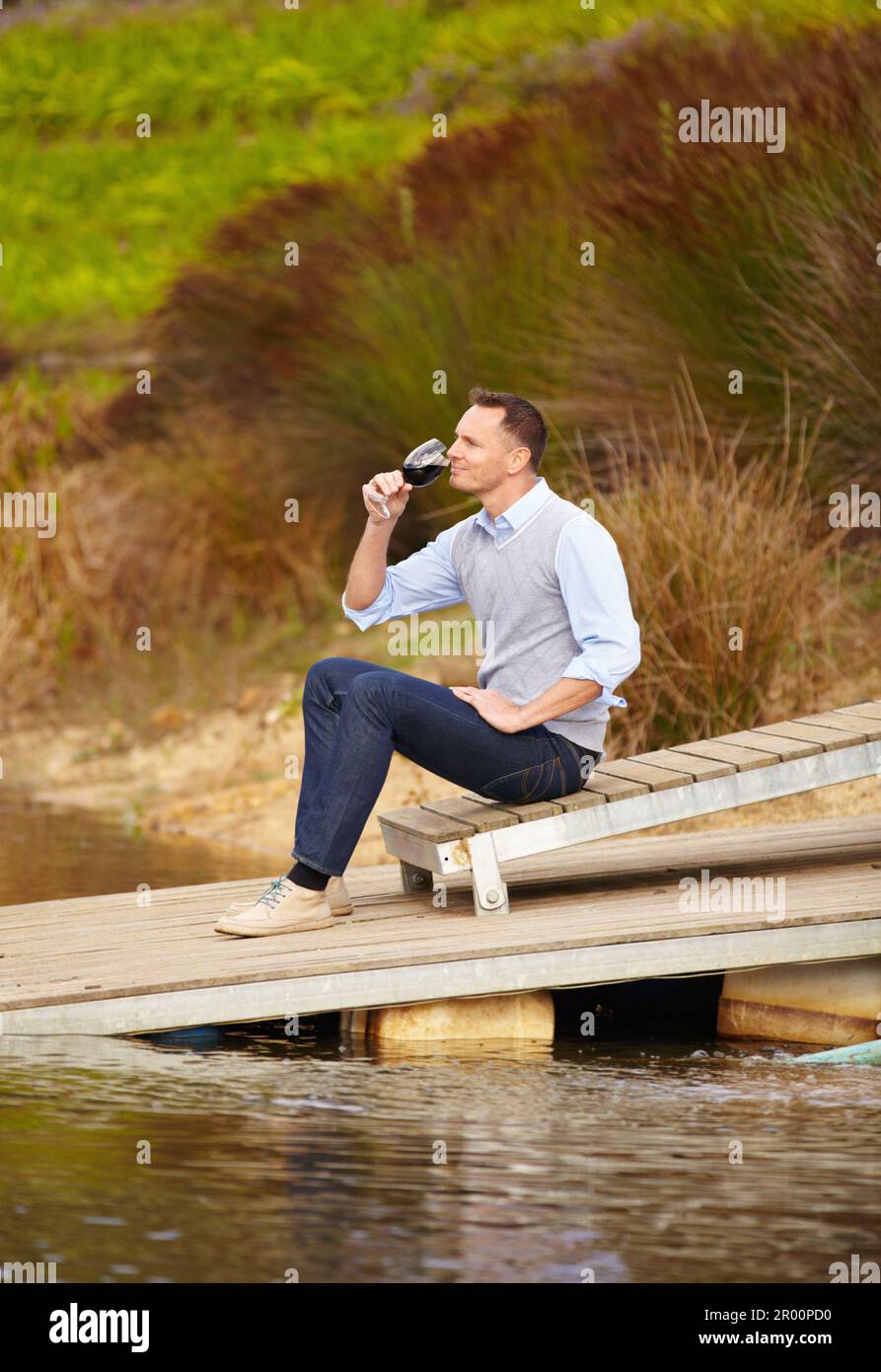 Thinking, river and a man drinking wine outdoor in nature on his farm ...