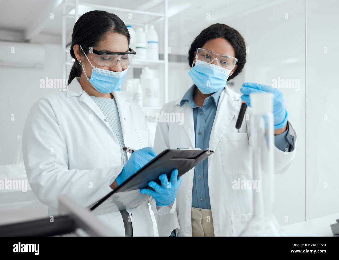 Partners in world of science. two female scientists reviewing a sample ...