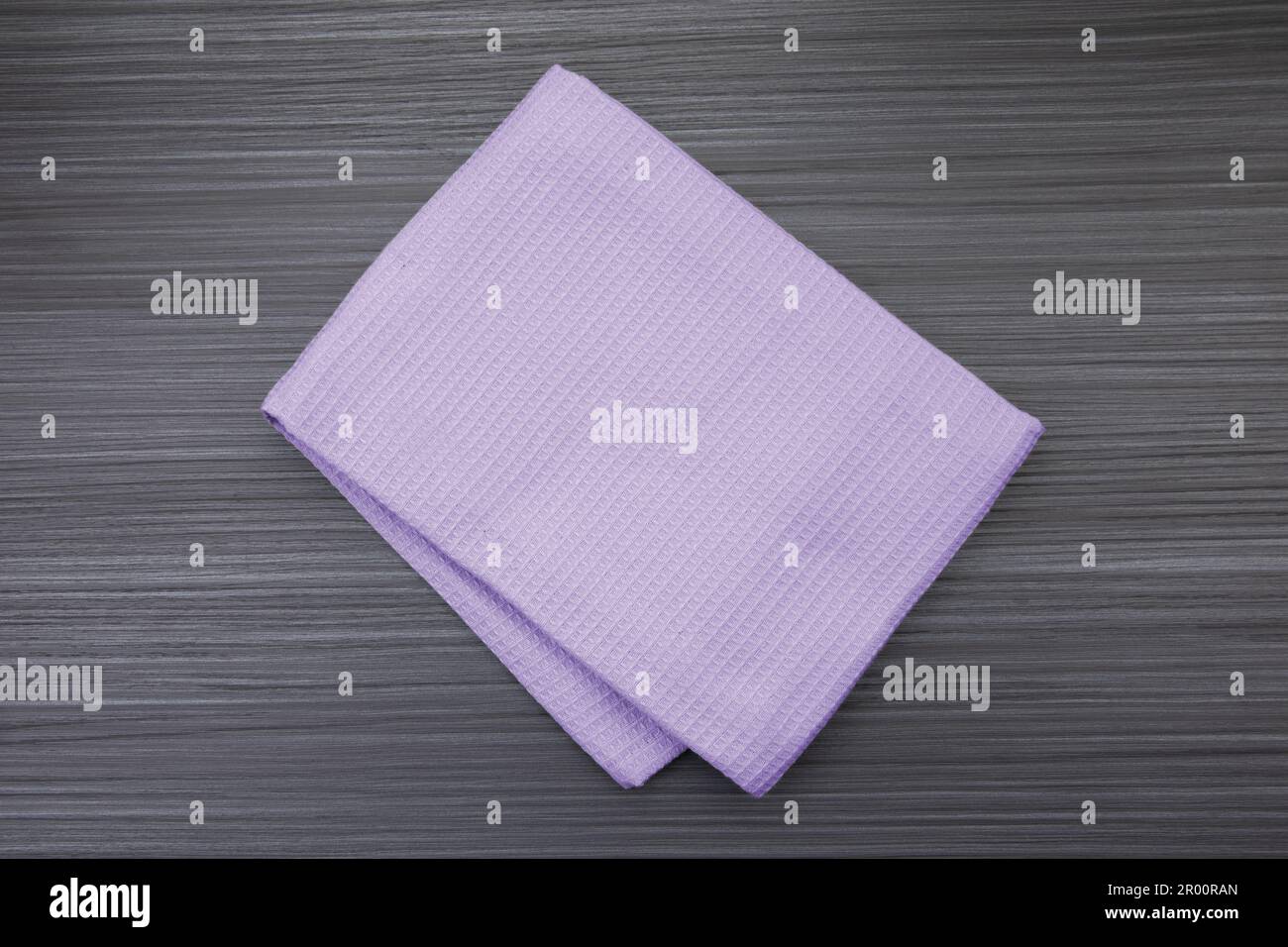 Purple tea towel on anthracite board with copy space Stock Photo - Alamy