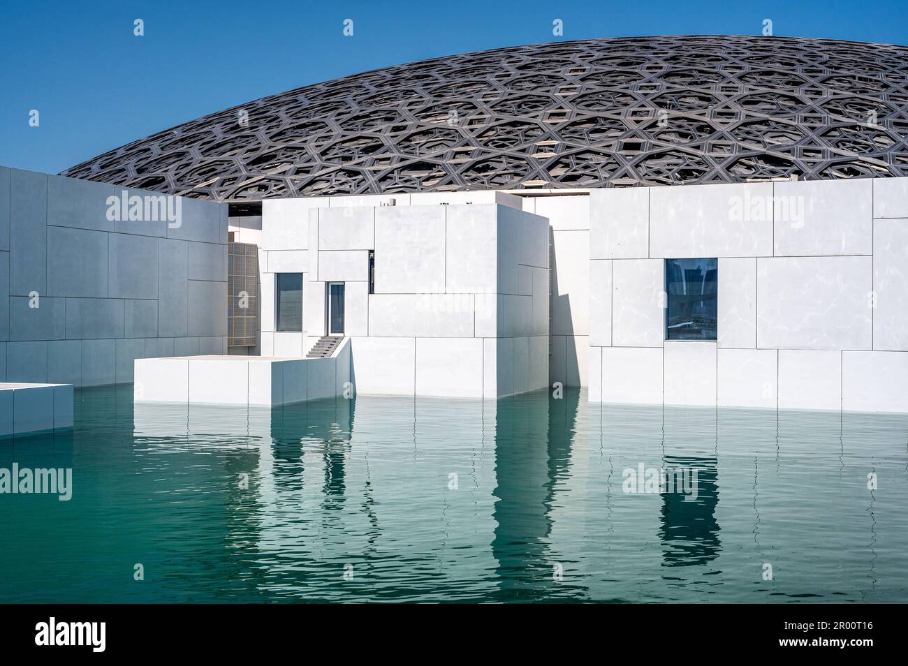 Exterior of Louvre Abu Dhabi famous museum. Plain white walls ...