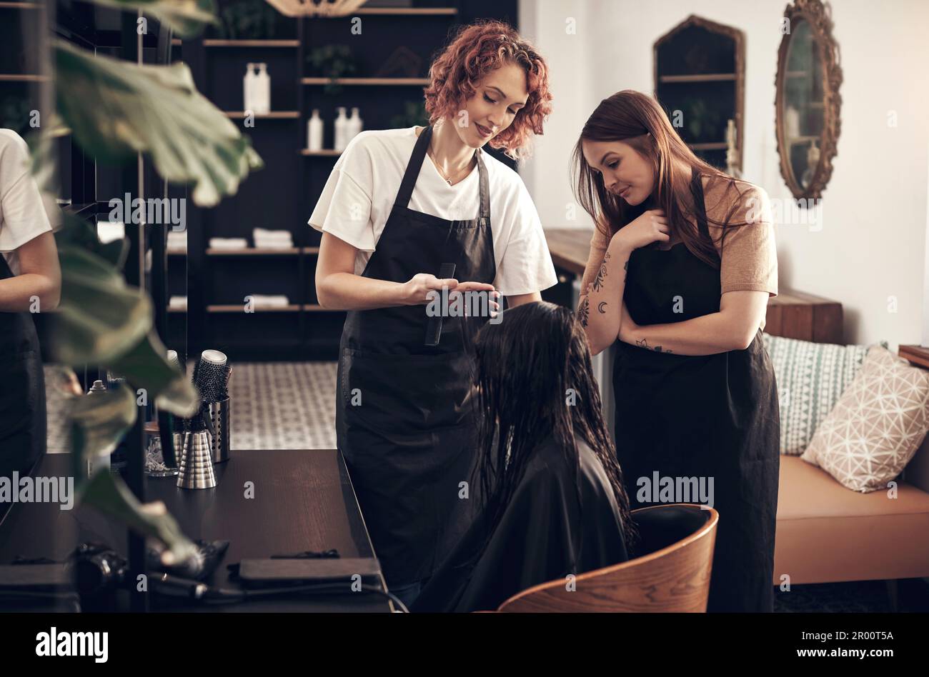 Look at this beautiful, long hair. two hairstylists looking at a ...