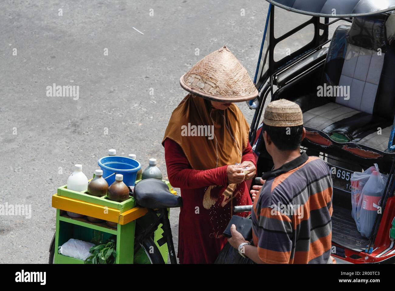 Herbal medicine sellers and their buyers. Jamu is a traditional drink ...