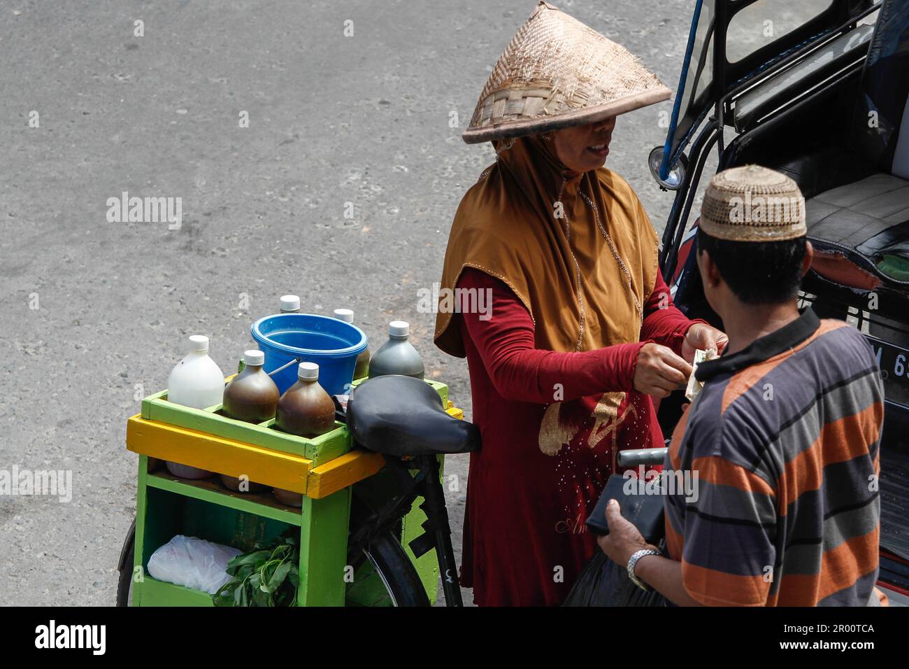 Herbal medicine sellers and their buyers. Jamu is a traditional drink ...