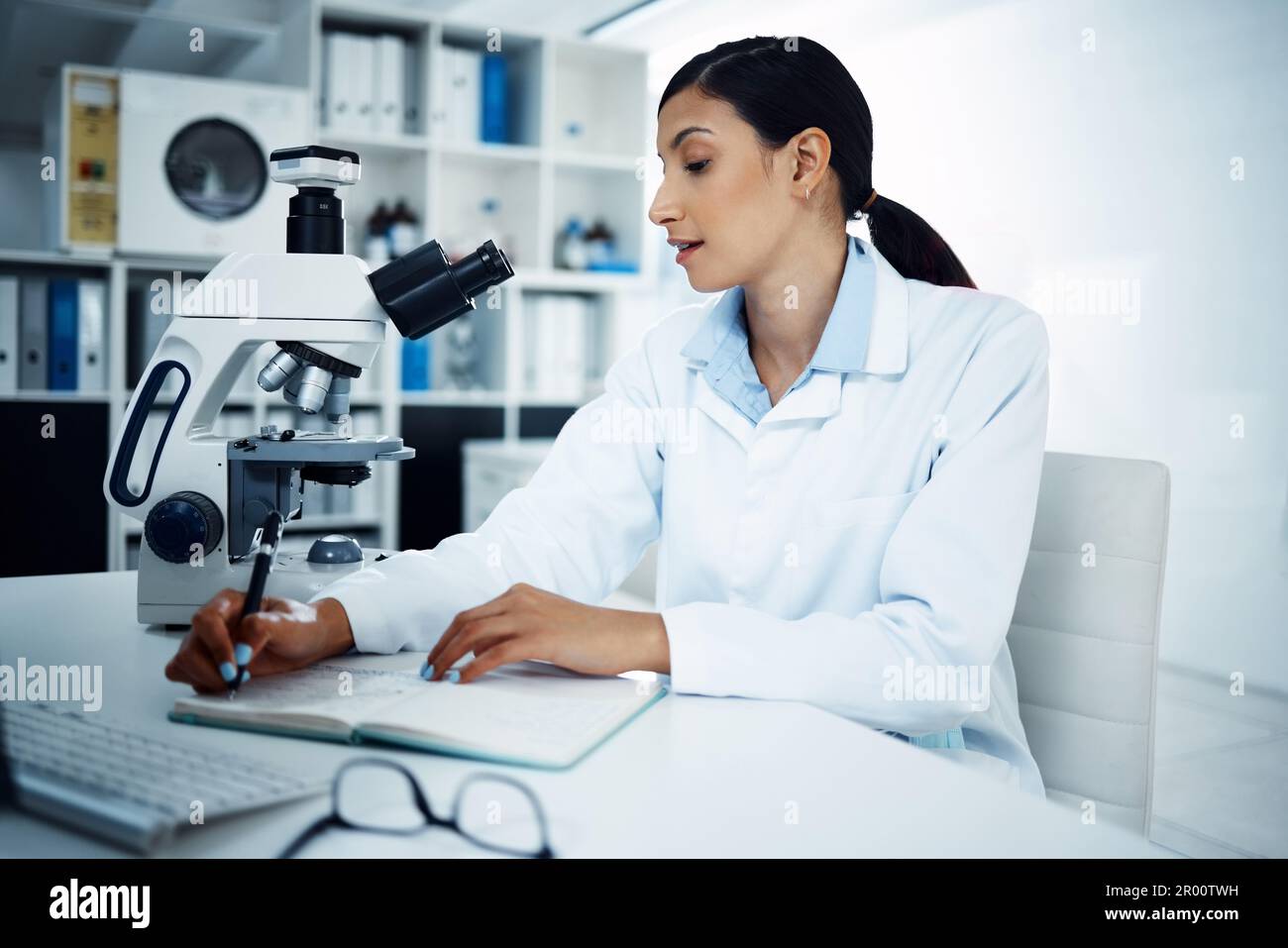 Take note of how expert research is done. a young scientist writing ...