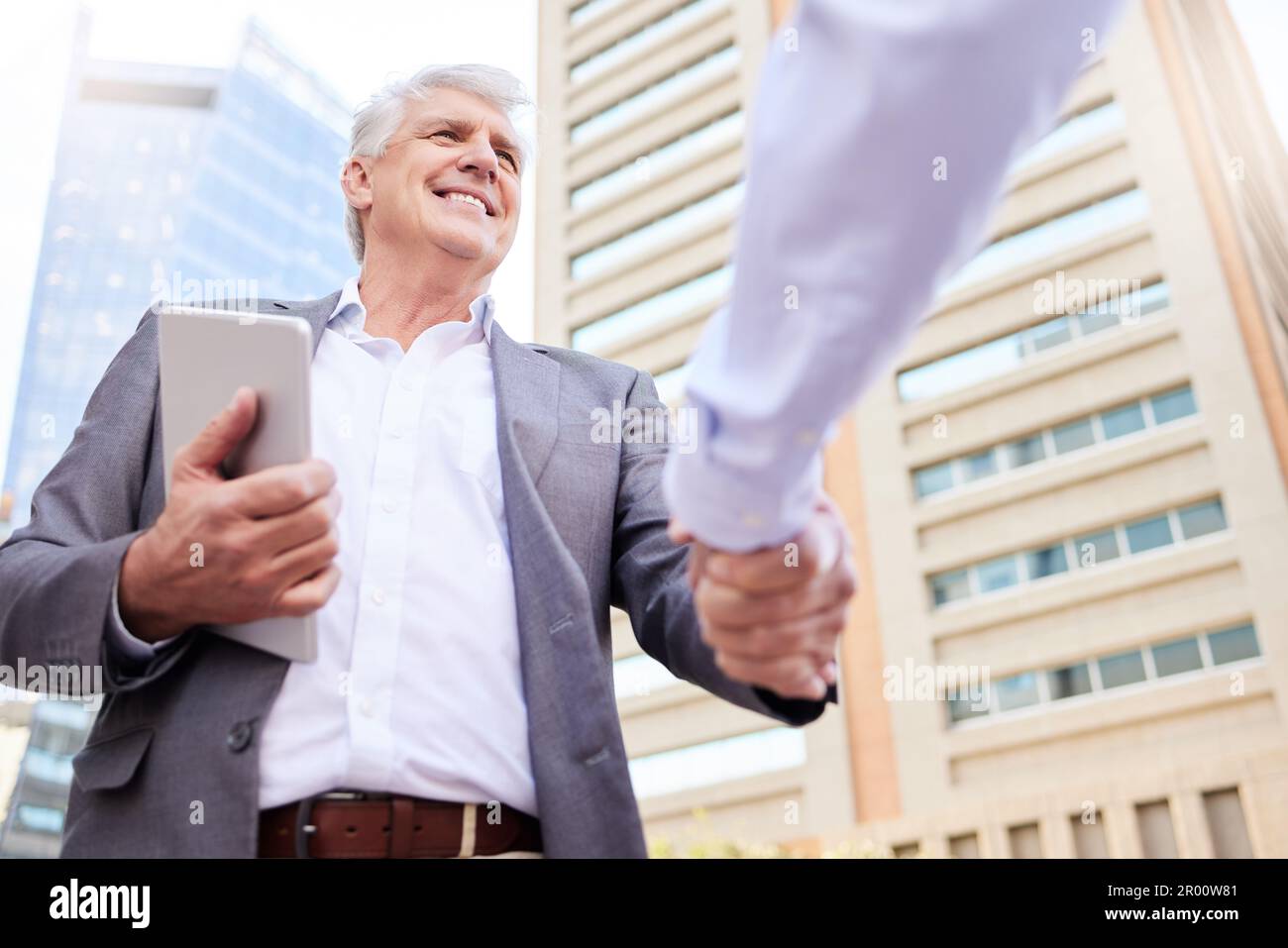 We just made a million dollar deal. Low angle shot of two businessmen ...