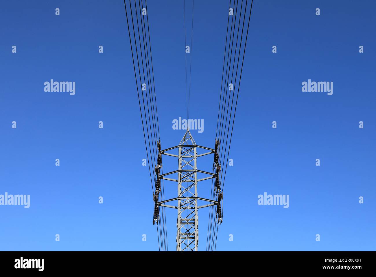 Electric high voltage power post with blue sky Stock Photo - Alamy