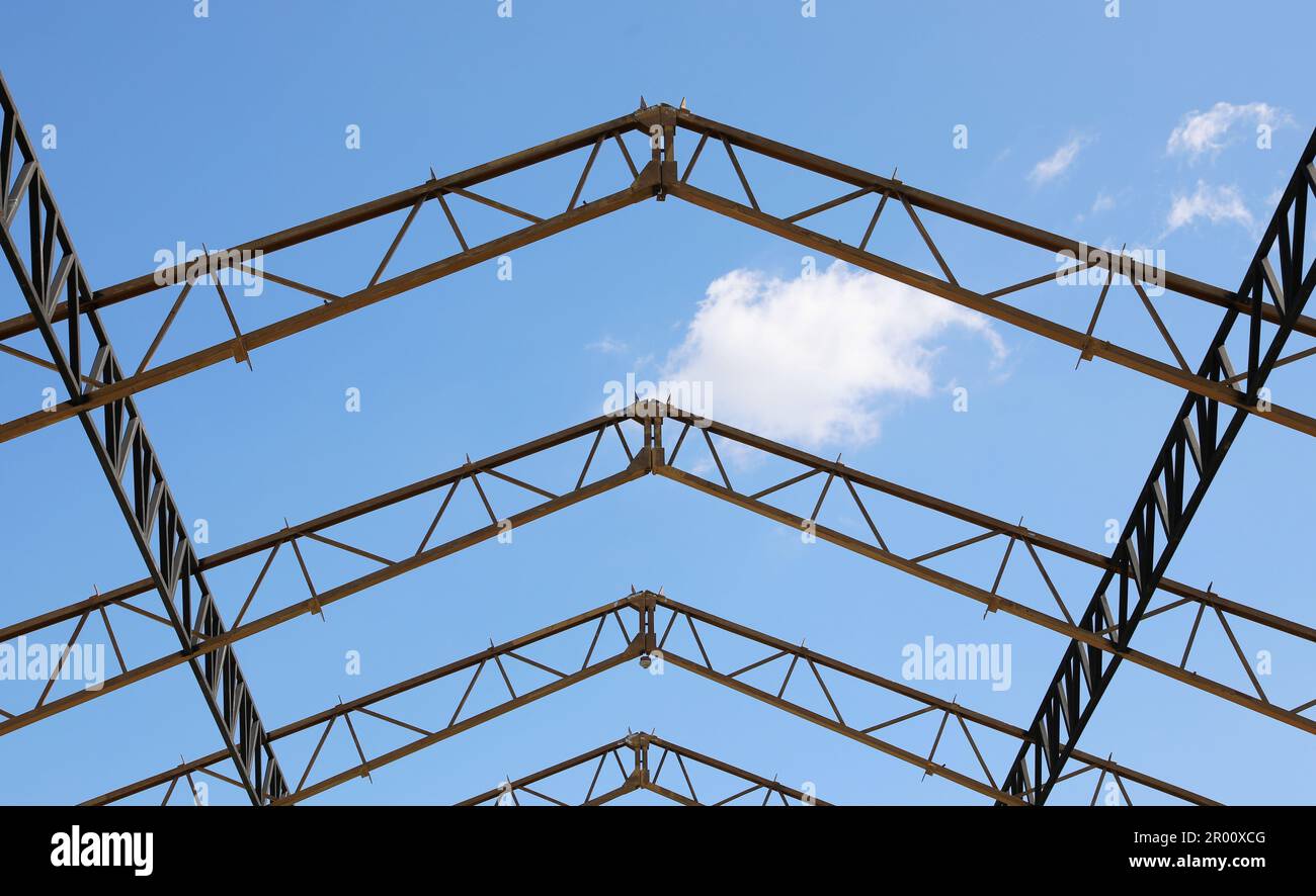 Steel structure with blue sky background Stock Photo - Alamy