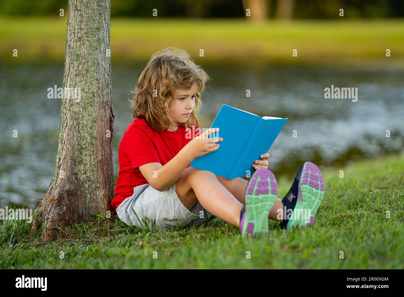 Smart clever Kids. Cute child read books outdoors. Kids learning and ...