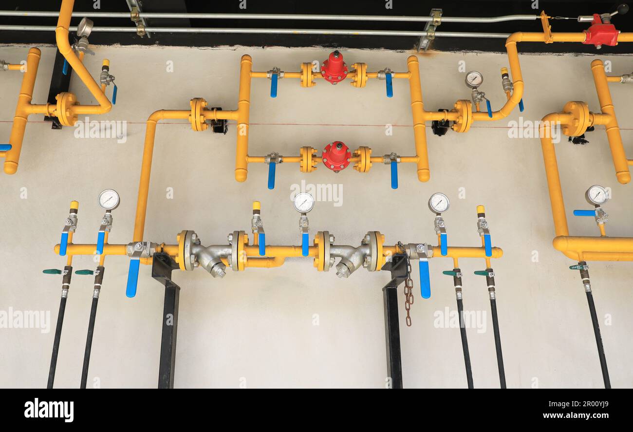 Yellow gas pipeline system installed on building wall Stock Photo - Alamy