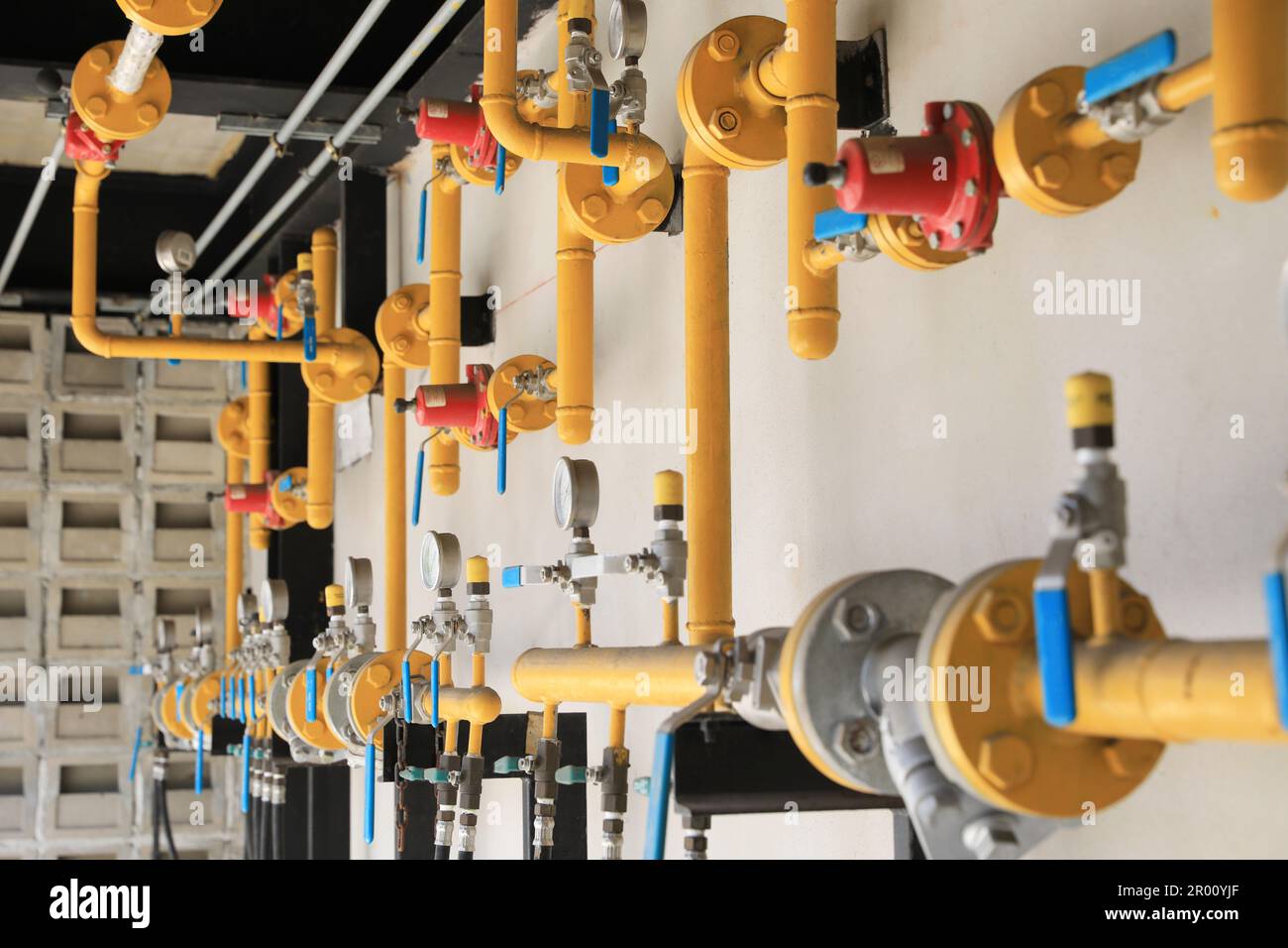 Yellow gas pipeline system installed on building wall Stock Photo - Alamy