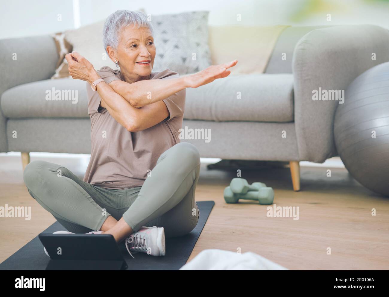 Im still quite bendy. an older woman doing light floor exercises at ...